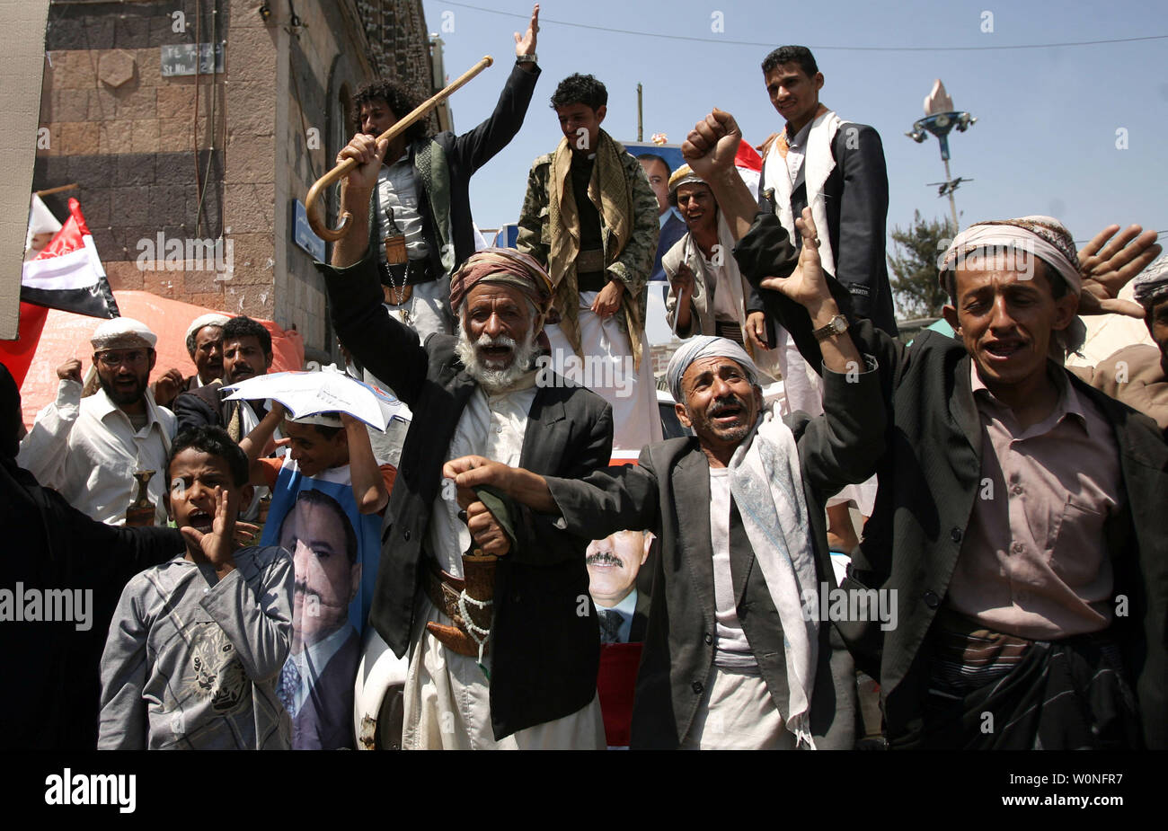 Yemeni men hold up portraits of President Ali Abdullah Saleh as they ...