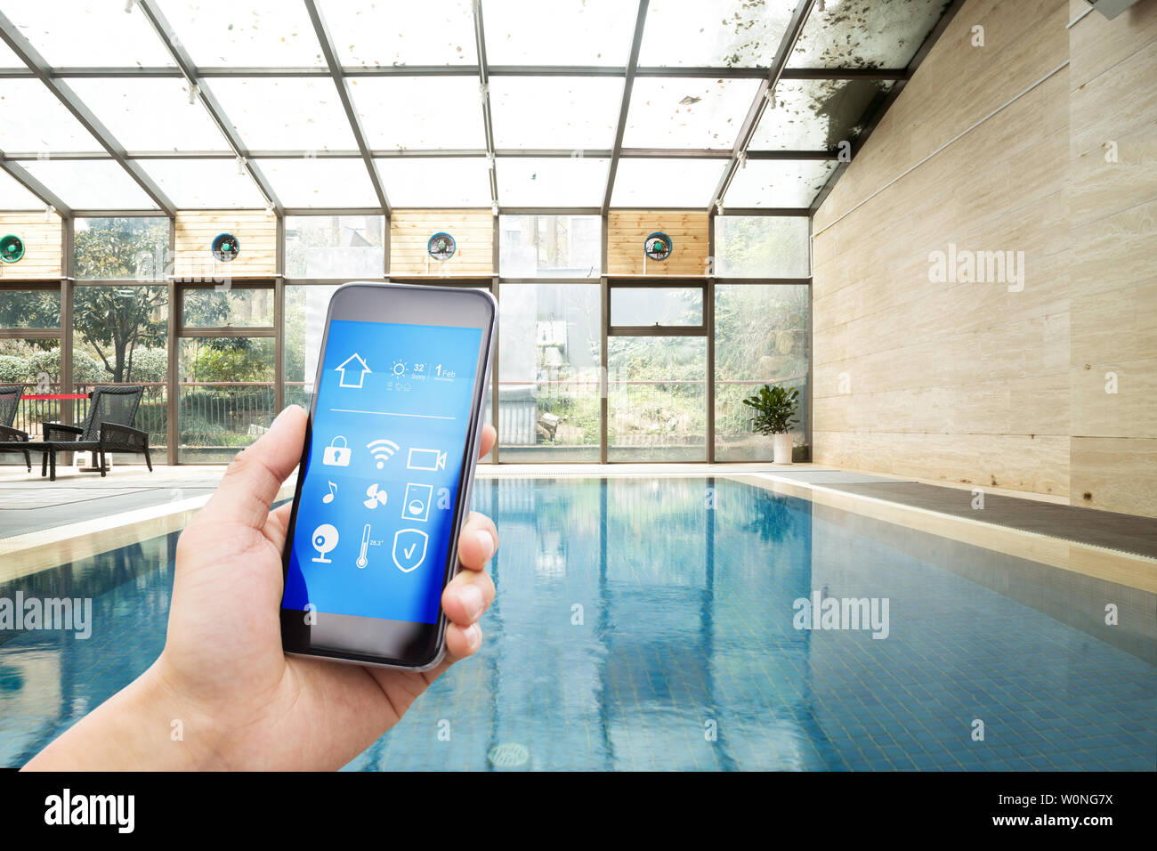 smart phone with smart home with modern swimming pool Stock Photo - Alamy
