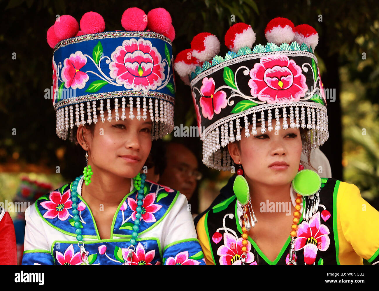 Chinese ethnic minorities wearing their traditional garb wait to dance ...