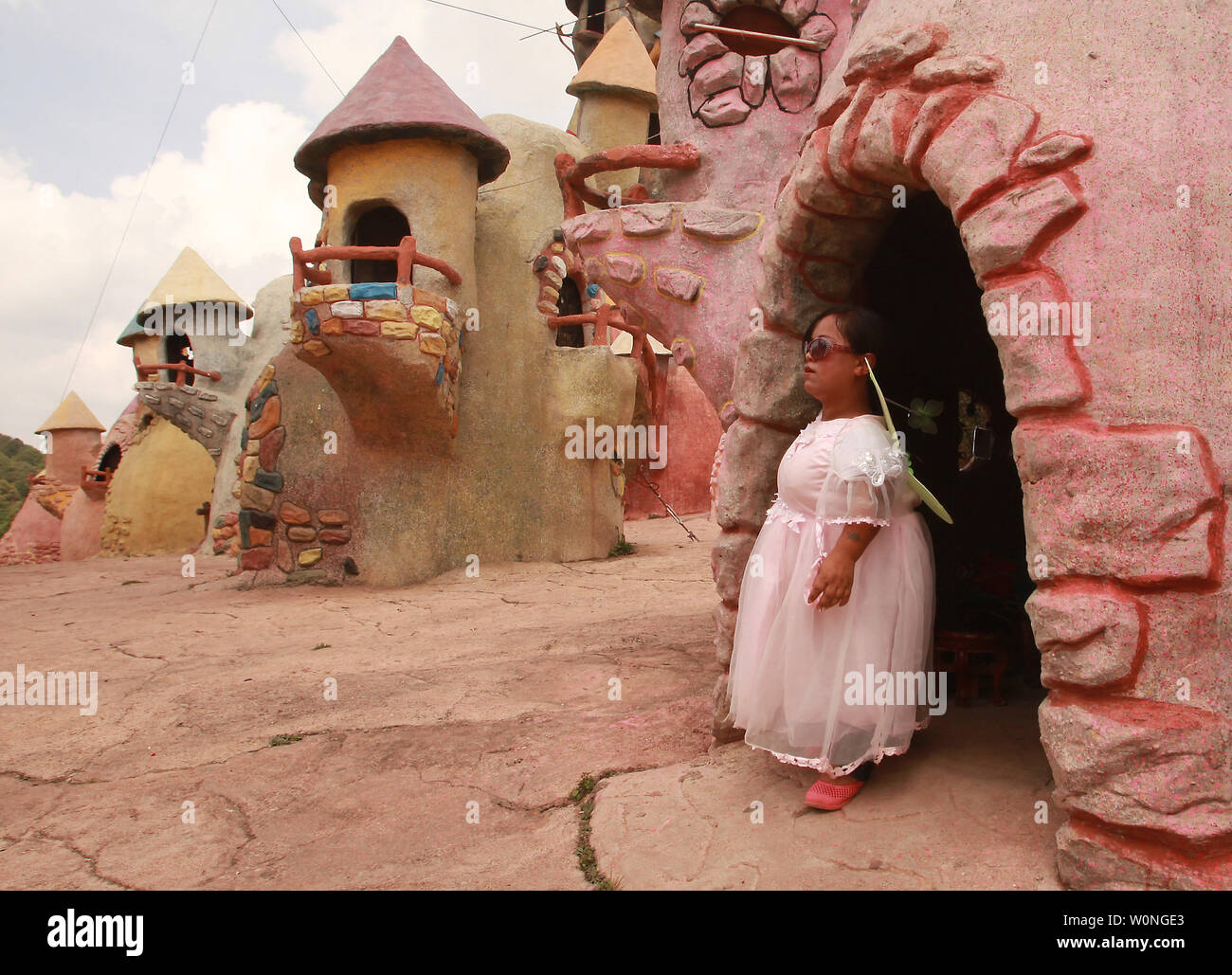 A fairy dwarf waits for the opening of a show featuring dwarves singing ...