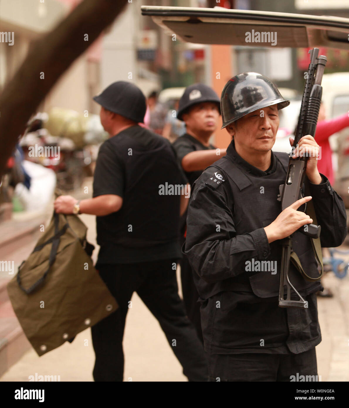 Armed Chinese security guards accompany the delivery of packages to a ...