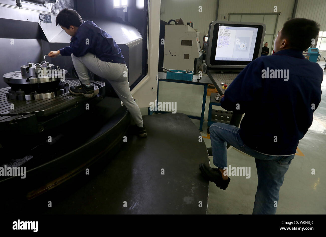 Chinese engineers monitor the precise drilling of aviation gas turbine ...
