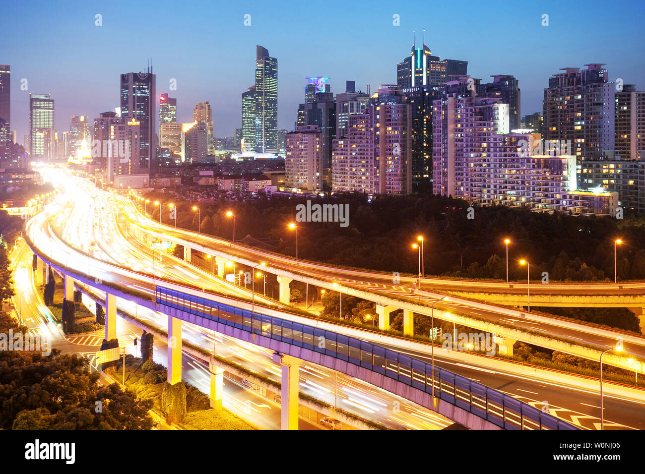 illuminated traffic on elevated expressway in modern city Stock Photo ...