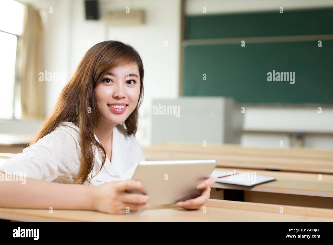 Asian beautiful woman using tablet in classroom Stock Photo - Alamy