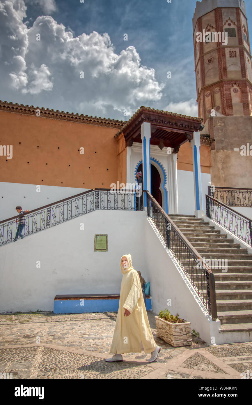Chefchaouen, Morocco - May 03, 2019: A man in Moroccan attire walks in ...