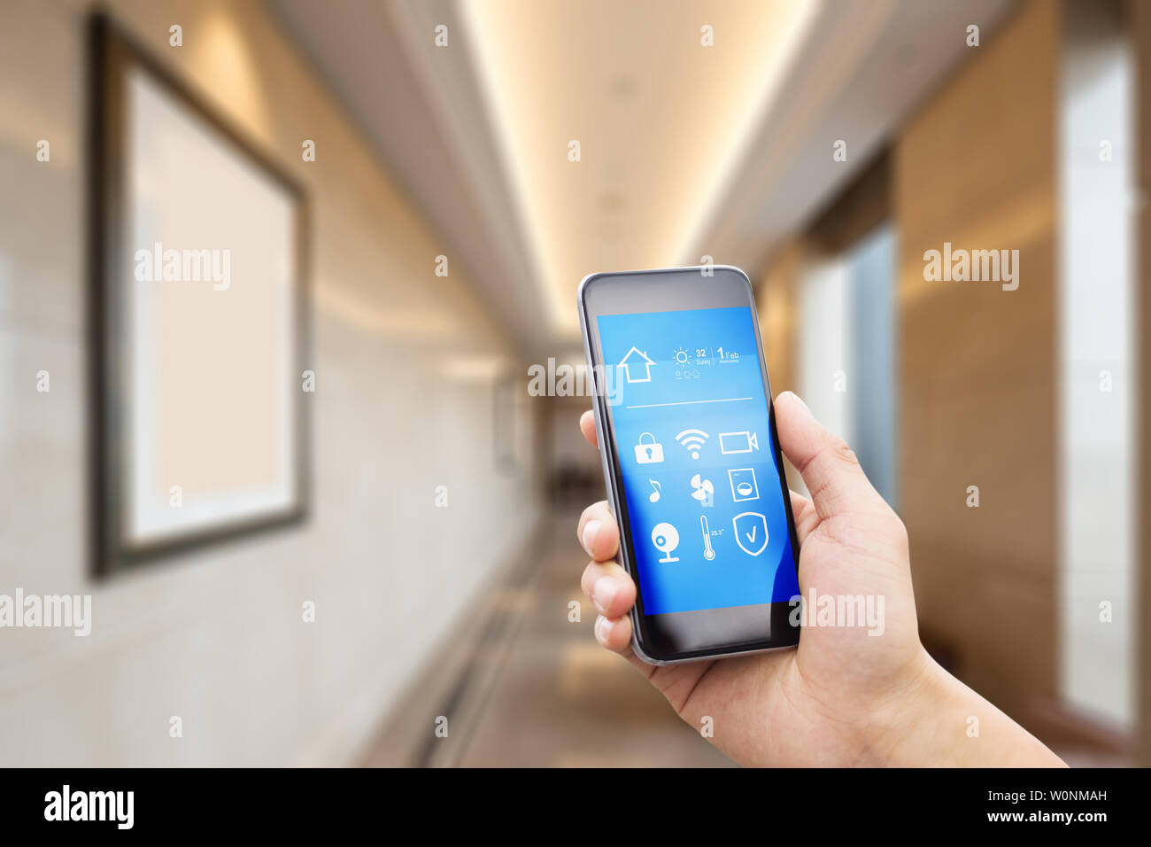 Mobile phone in smart home Stock Photo - Alamy