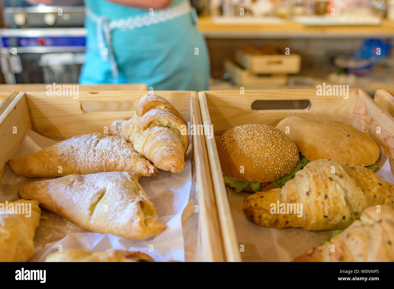 croissants and burgers on the counter in the bakery. Croissants on a ...
