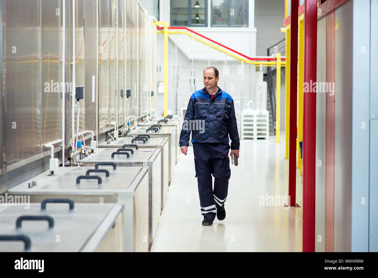 Factory worker inspecting factory machines Stock Photo - Alamy