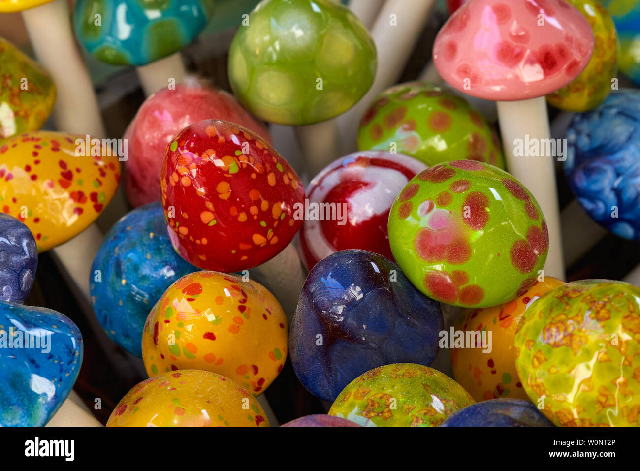 colorful background of ceramic toadstools in various patterns with dots ...