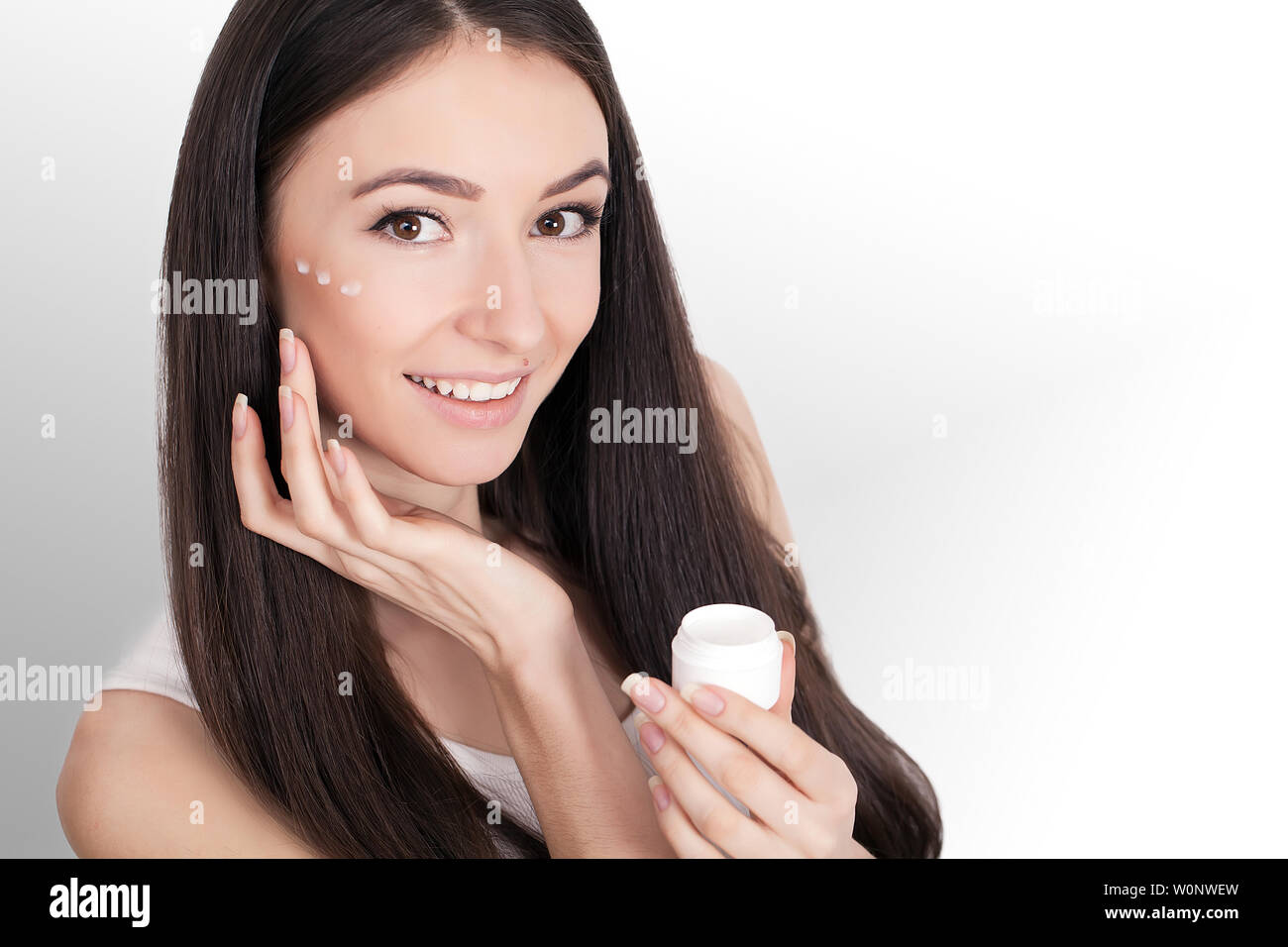 Beauty face of woman with cosmetic cream on face Stock Photo - Alamy