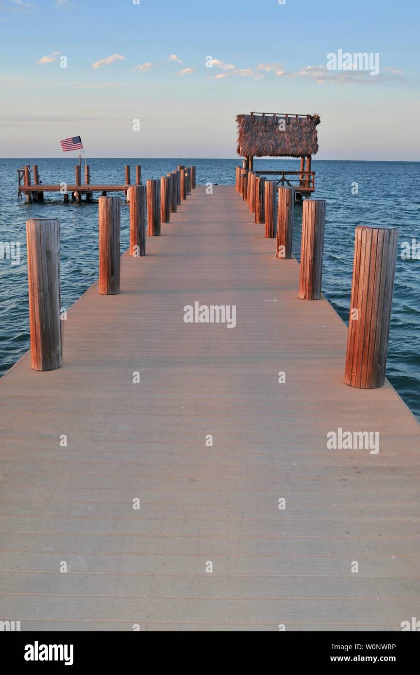 Dock with symmetrical wooden posts jutting out into the Gulf of Mexico ...