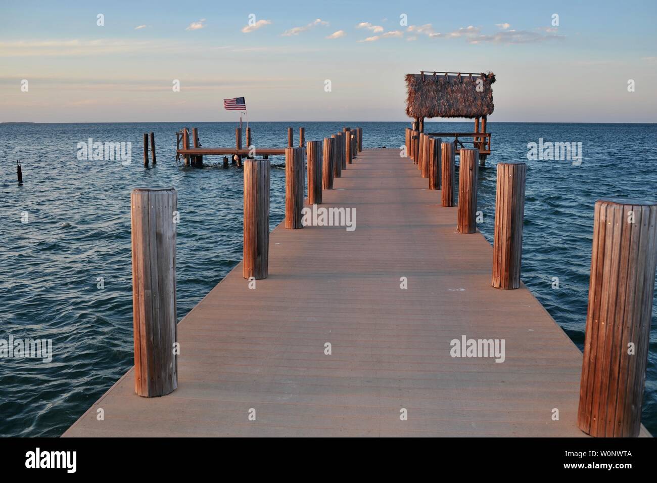 Dock with symmetrical wooden posts jutting out into the Gulf of Mexico ...