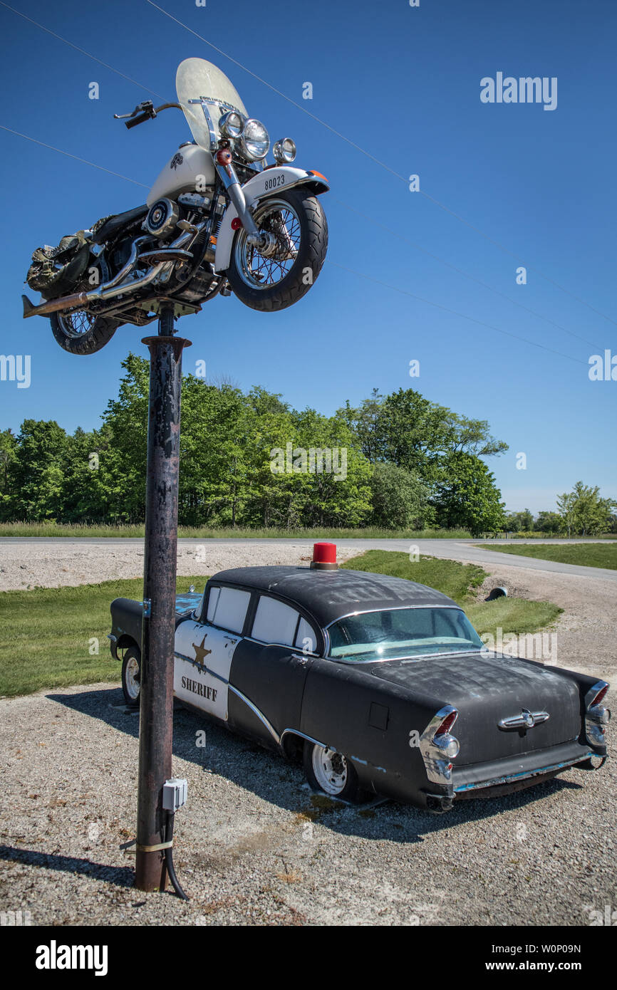 A perched police motorcycle and an old sheriff police cruiser Stock ...