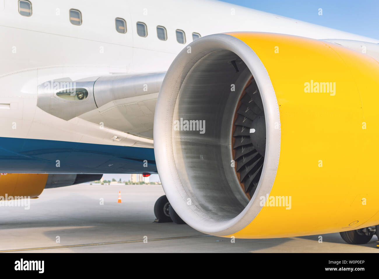 Close-up big commercial plane engine standing on airfiled after ...
