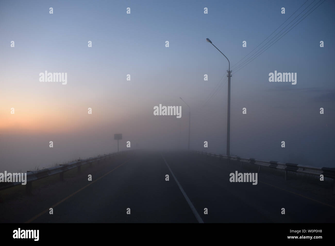 Midnight car track covered with fog Stock Photo - Alamy