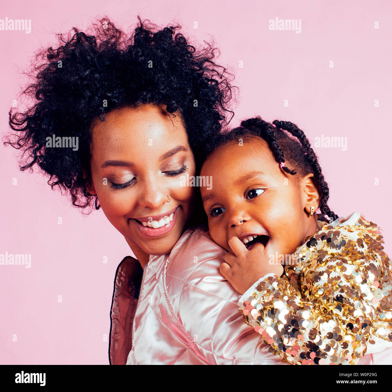young pretty african-american mother with little cute daughter hugging ...