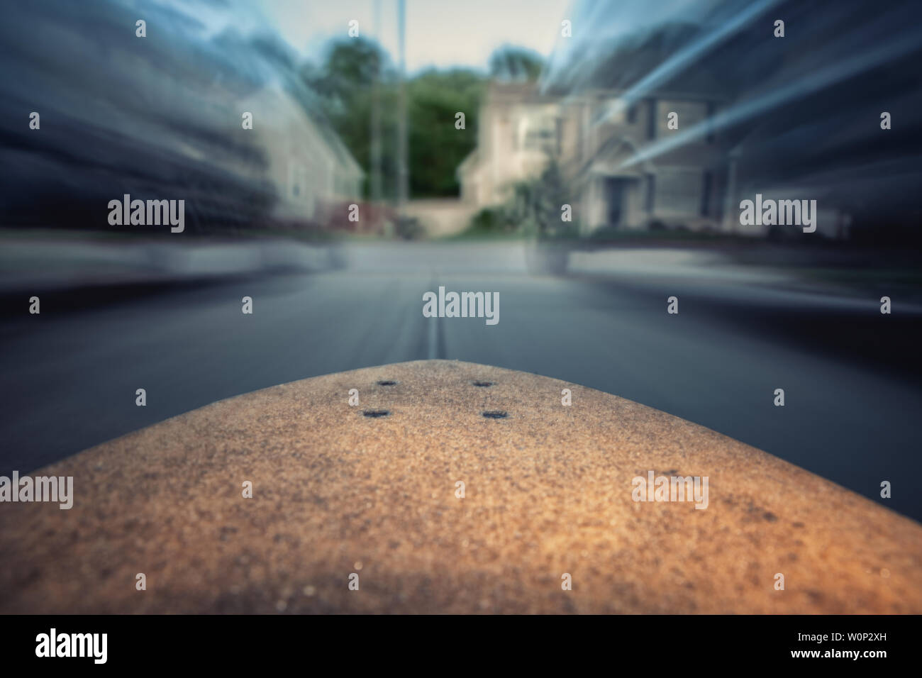 Low perspective shot from the deck of a skateboard as it moves past ...