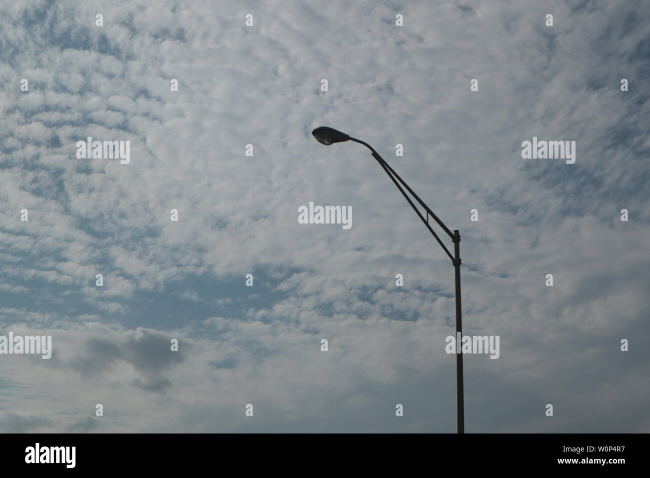 Lonely Lamp post on cloudy sky Stock Photo - Alamy