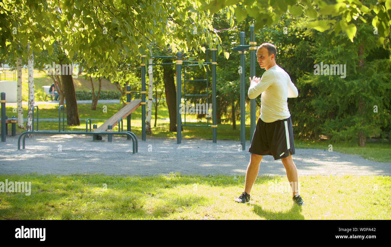 Man bodybuilder perform the warm-up before basic exercises - Mid shot ...