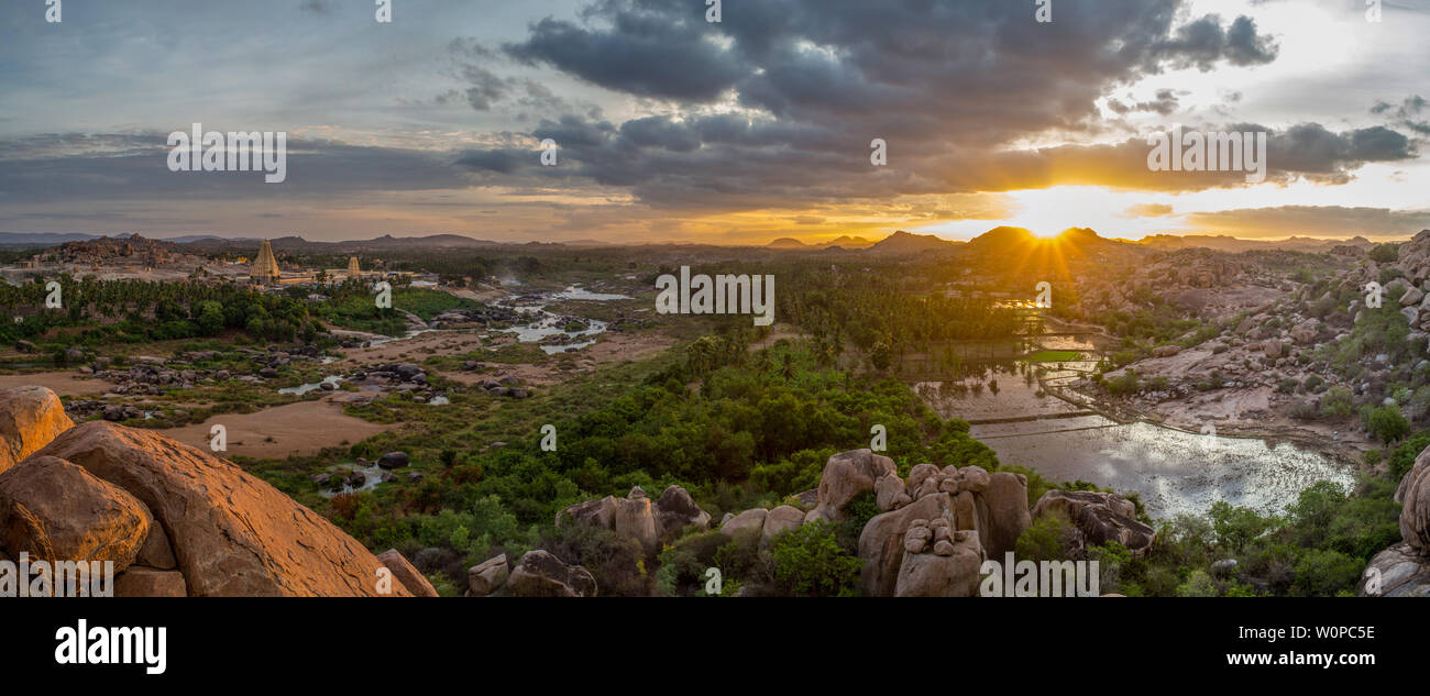 A view over Hampi with its temples, rivers and rice fields, at sunset ...