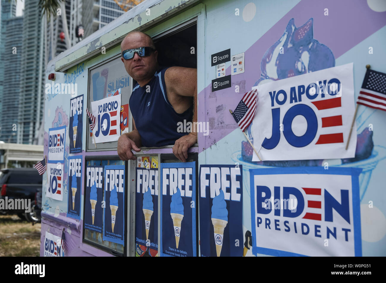 Miami, Florida, USA. 27th June, 2019. A Joe Biden supporter gives out ...