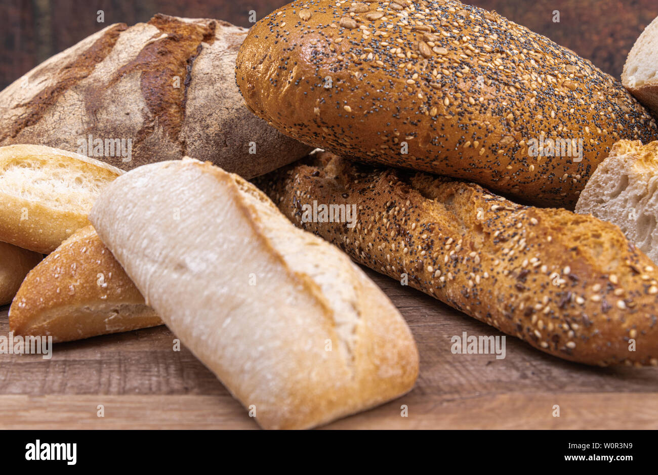 Assortment of baked bread on table background. food concept Stock Photo ...