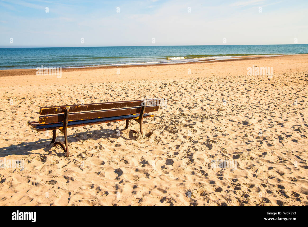 bench on a lonesome beach of the Baltic Sea with blue sky Stock Photo ...
