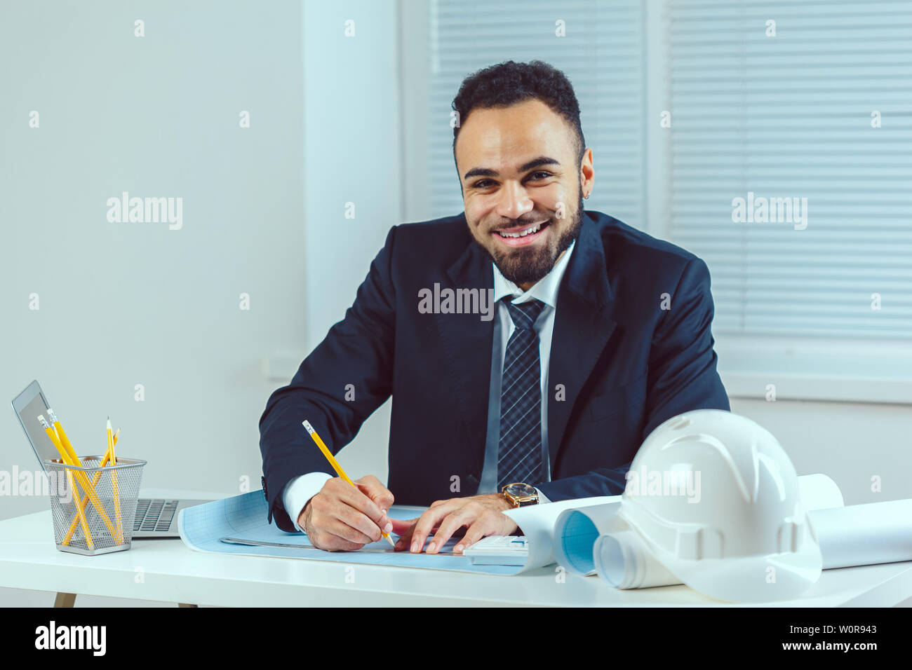 architect sitting at desk and working Stock Photo - Alamy