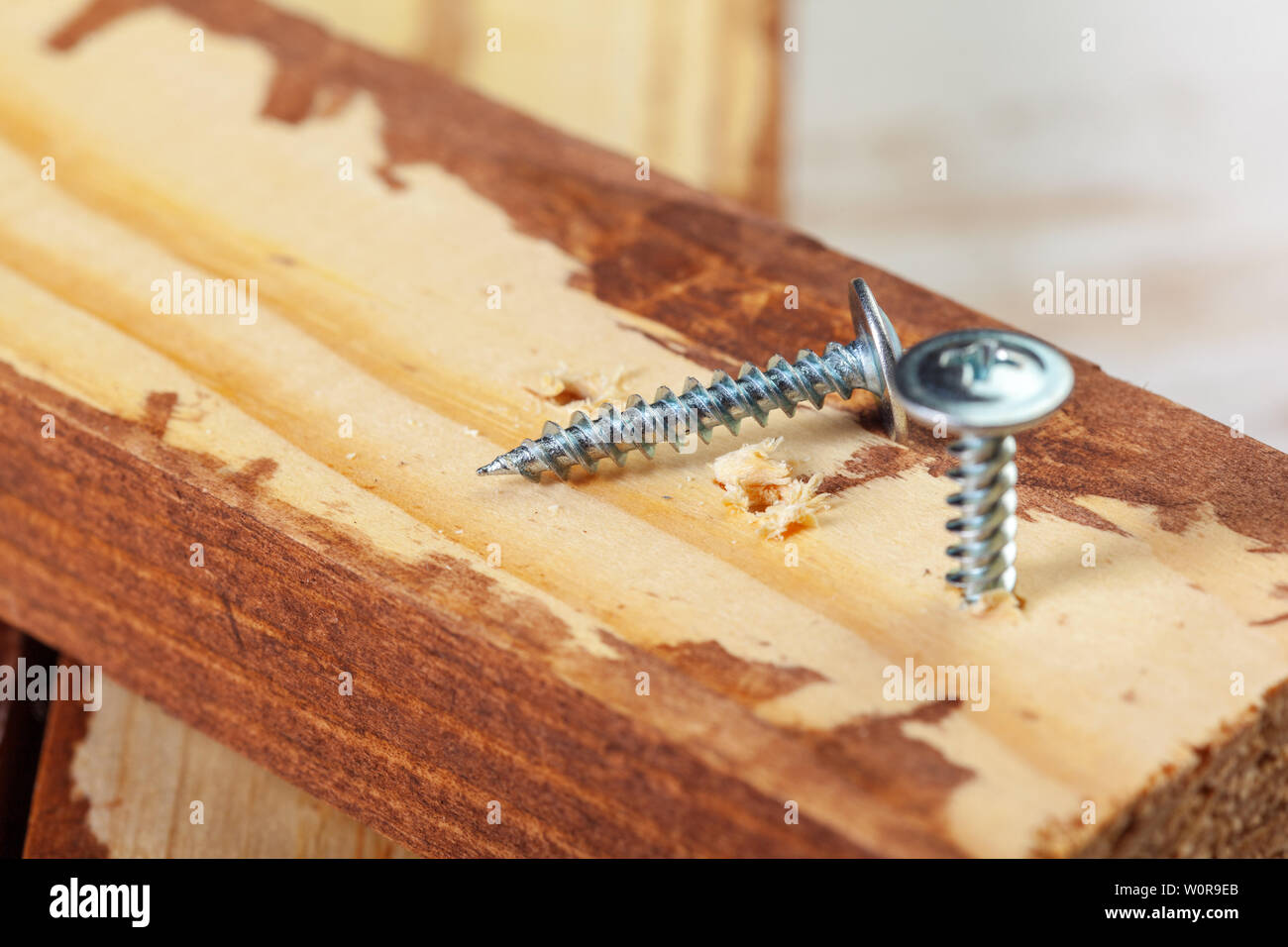 screw screwed into a wooden bar Stock Photo - Alamy