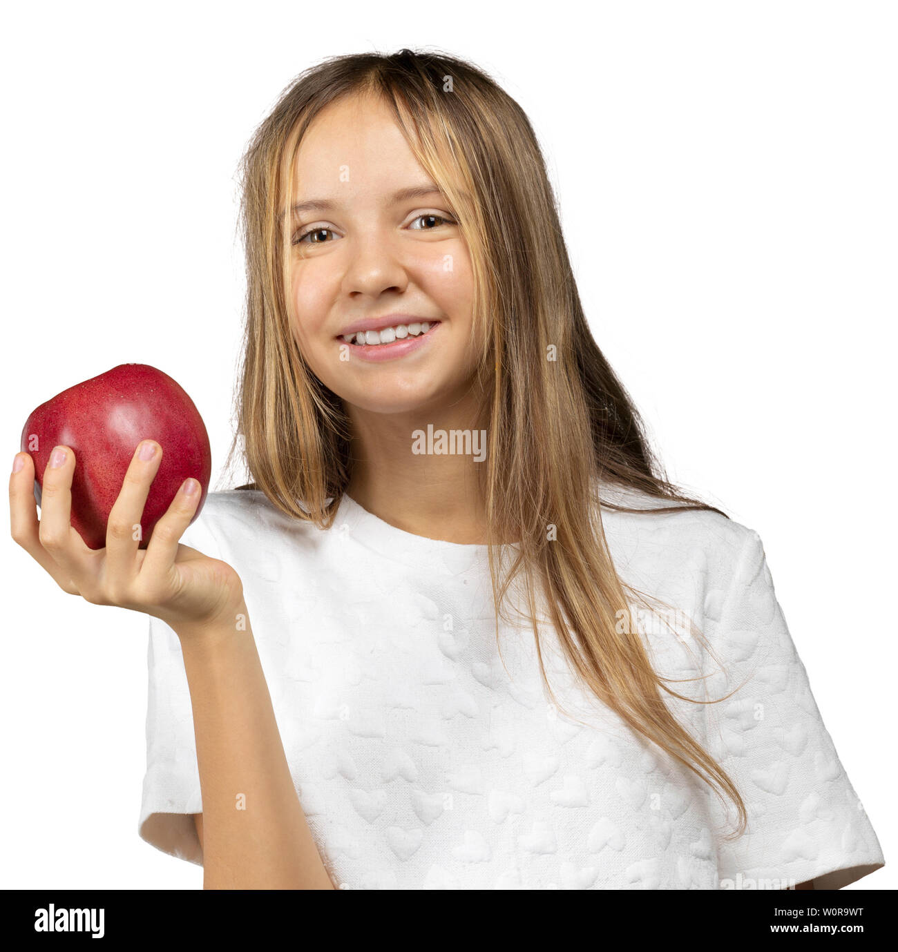 Pretty curly little girl standing and holding red apple over white ...