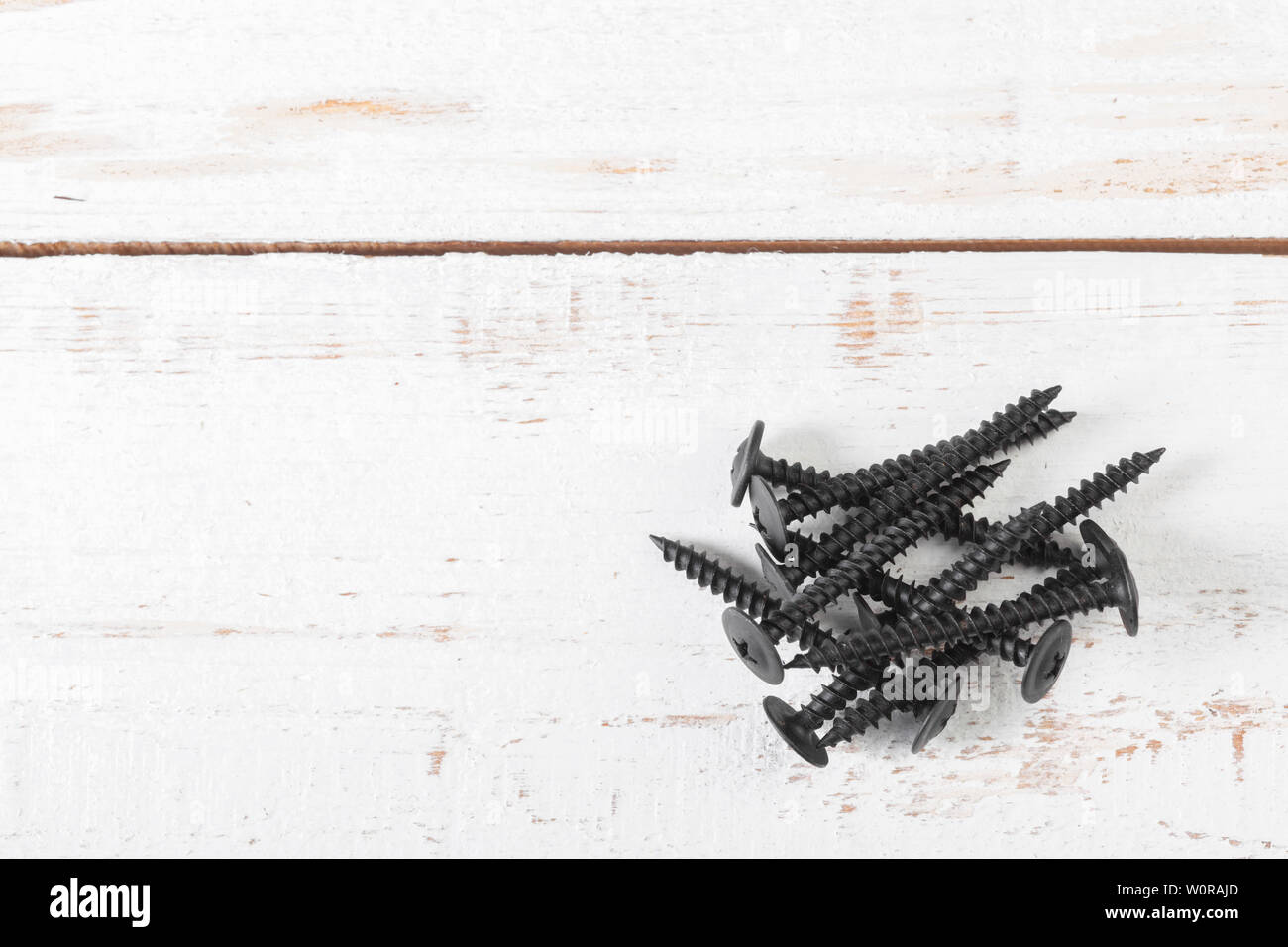 screws on a wooden table Stock Photo - Alamy