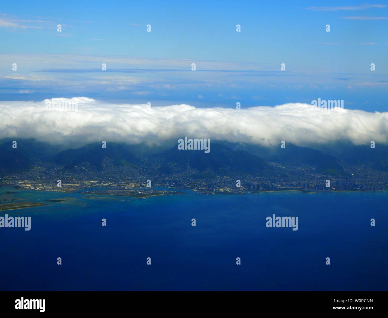 Aerial of Honolulu with clouds hovering above, Waikiki, Buildings ...