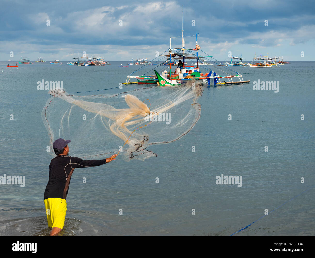 Kiamba, The Philippines - May 31, 2019: Local fisherman throwing his ...