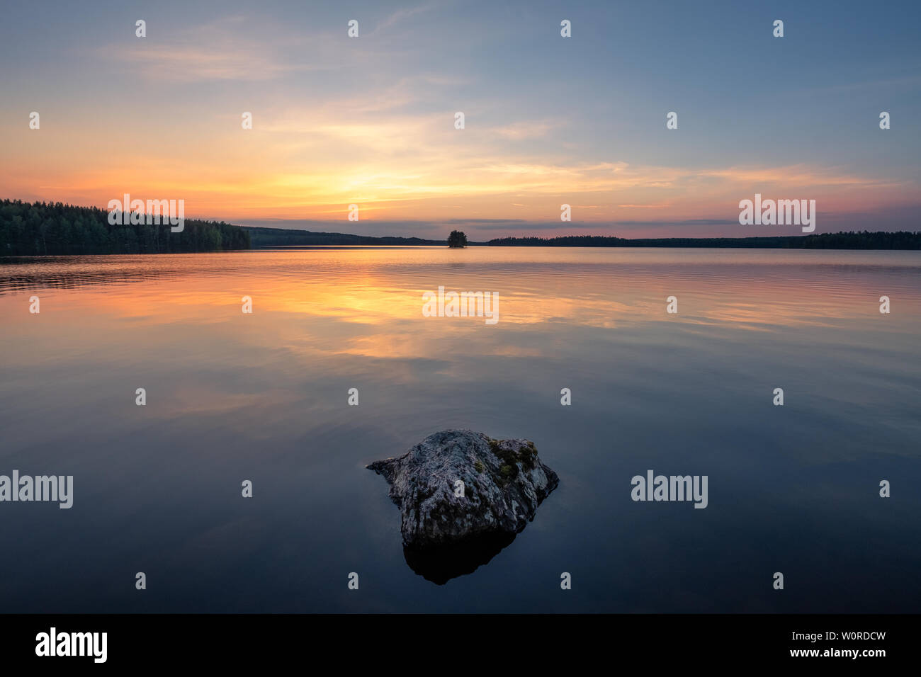 Scenic landscape with beautiful sunset and lake at summer evening in ...