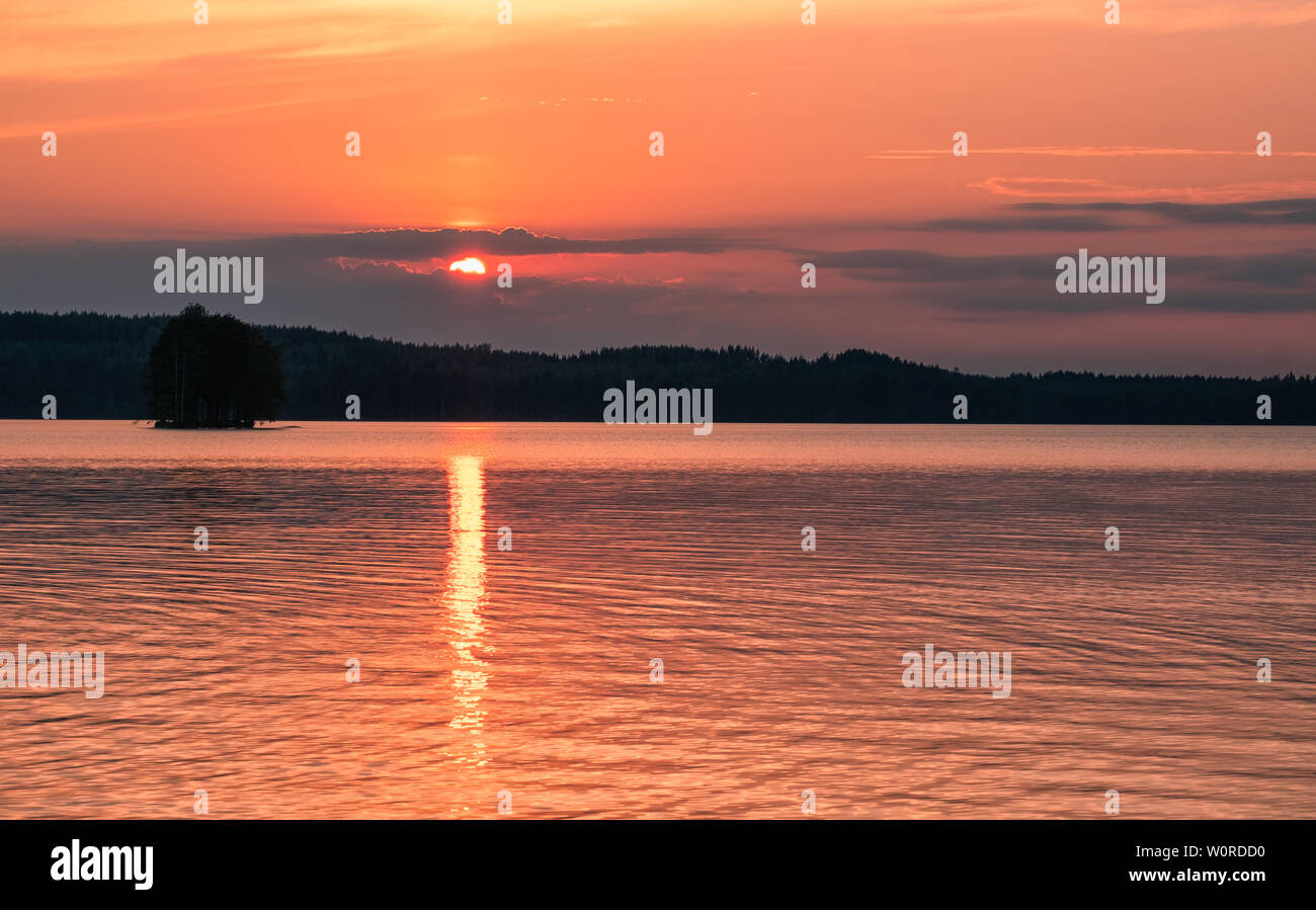 Scenic landscape with beautiful sunset and lake at summer evening in ...