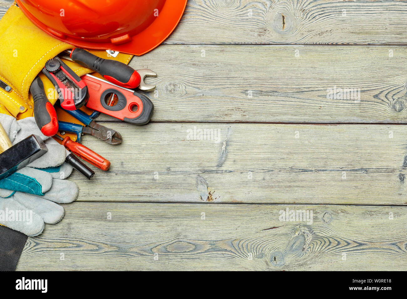 Assorted work tools on wooden table Stock Photo - Alamy