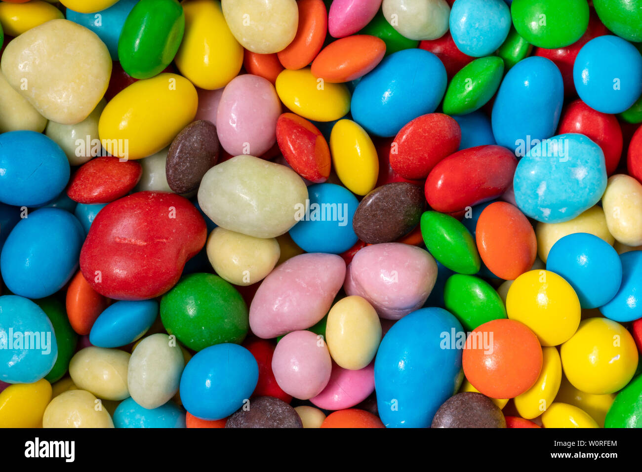 Colorful candies background. Nuts in multi-colored glaze dragee. Pile ...