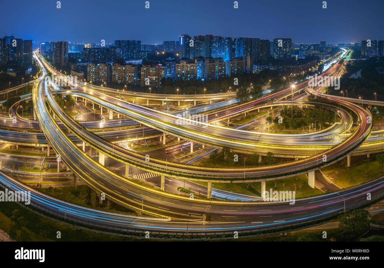 Large interchange with busy traffic aerial view at night in Chengdu ...