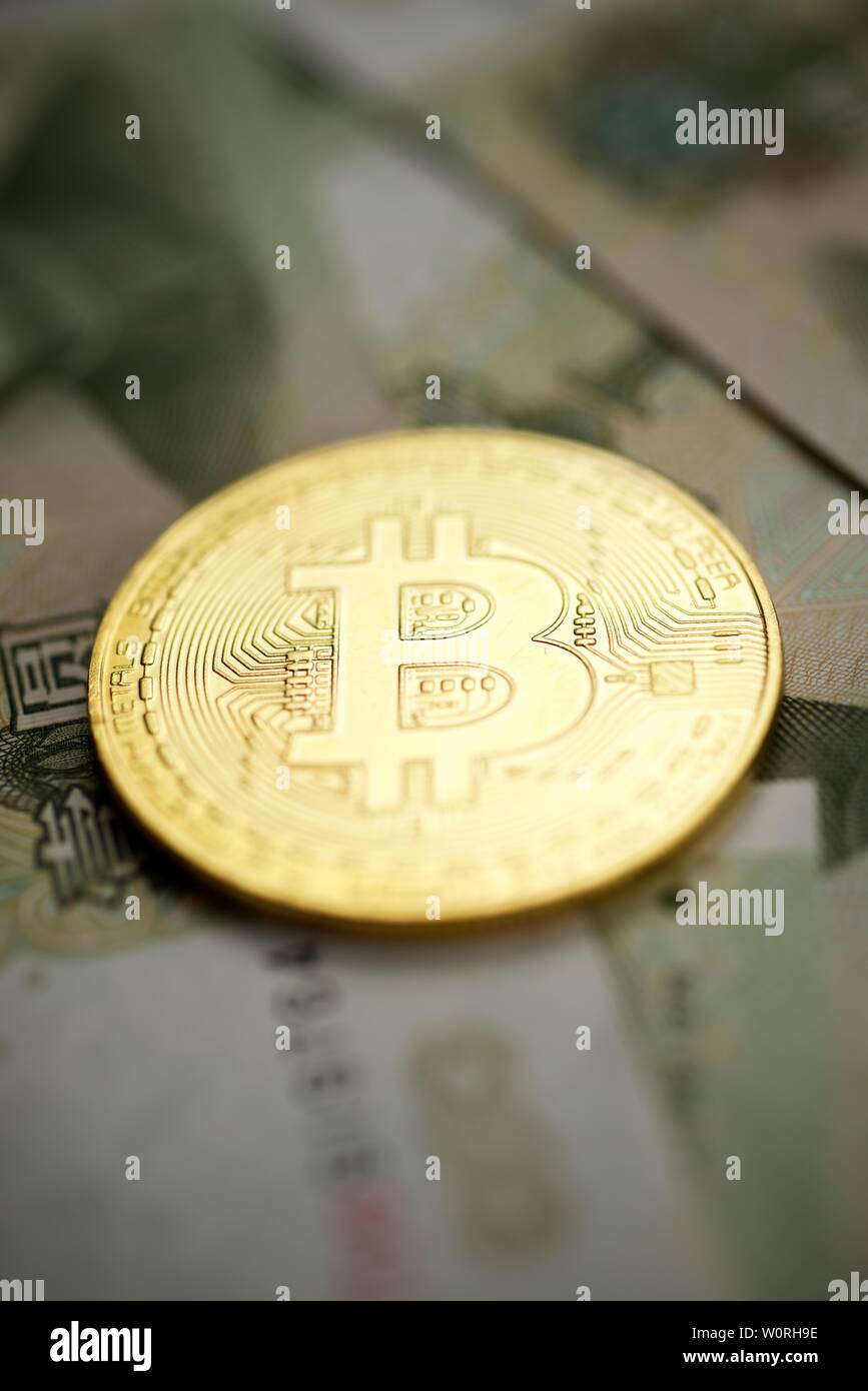 Bitcoins on a dollar banknotes Stock Photo - Alamy