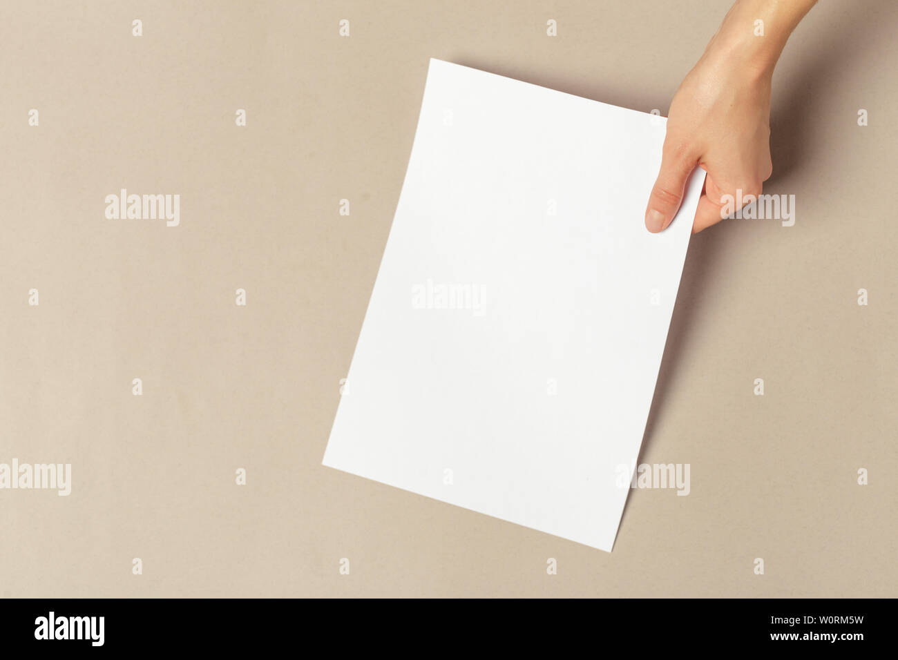 Hand holding papers a4 size Stock Photo - Alamy