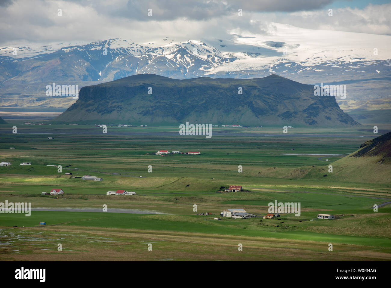 Icelandic landscape with volcanic lava ridge, glacier mountains, green ...