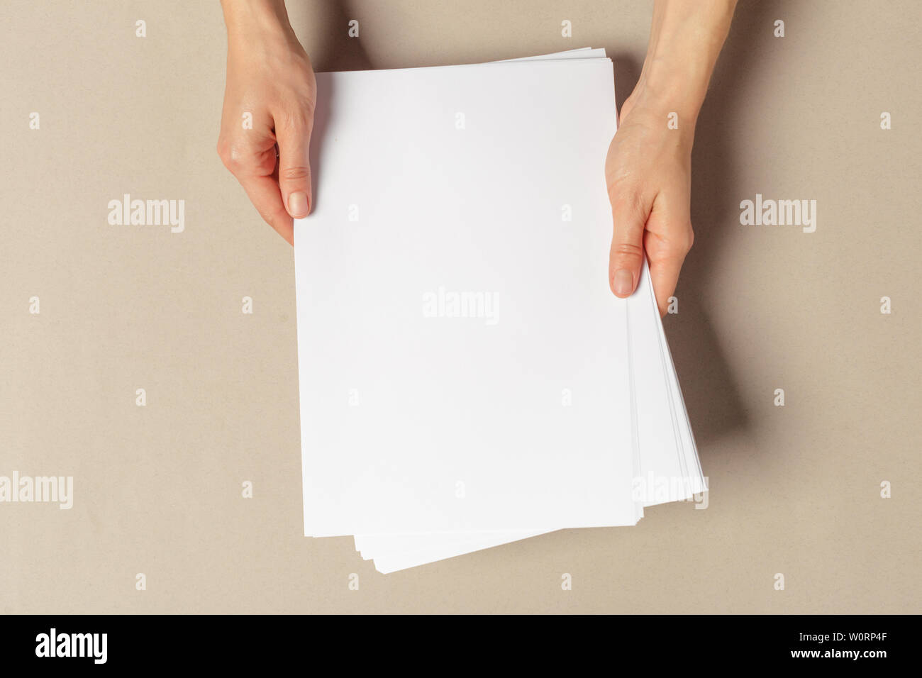 Hand holding papers a4 size Stock Photo - Alamy