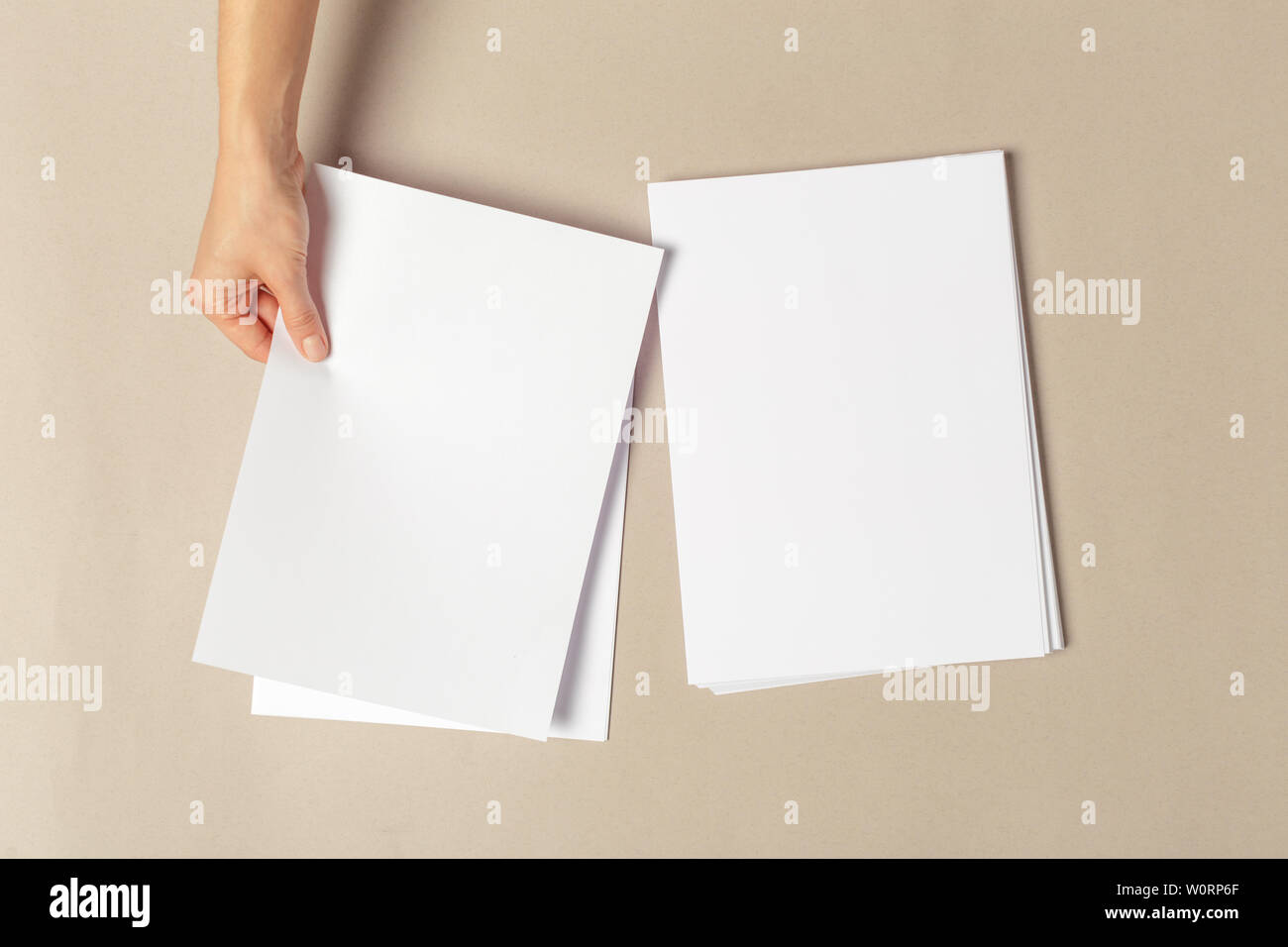 Hand holding papers a4 size Stock Photo - Alamy