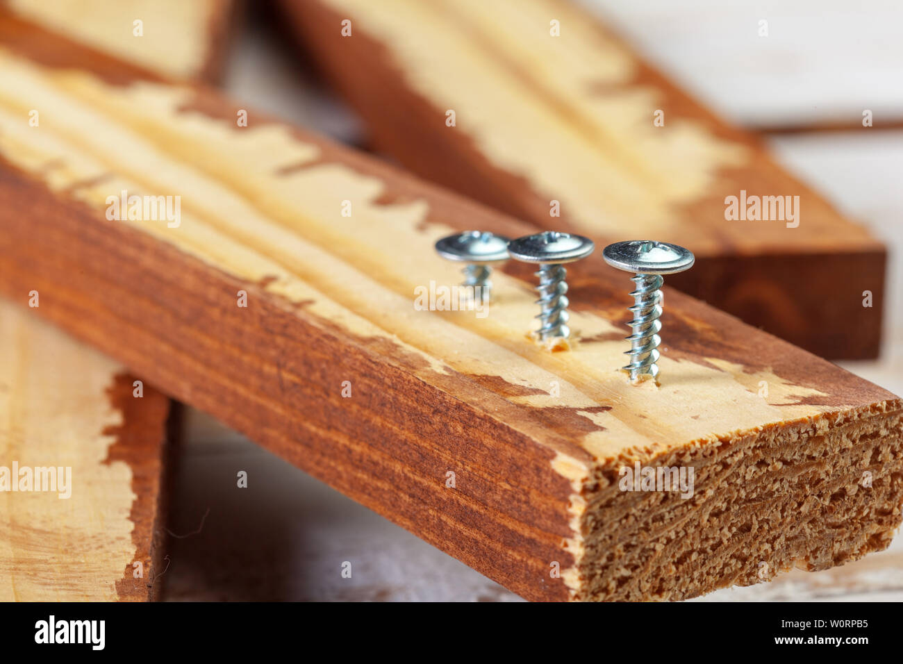 screw screwed into a wooden bar Stock Photo - Alamy