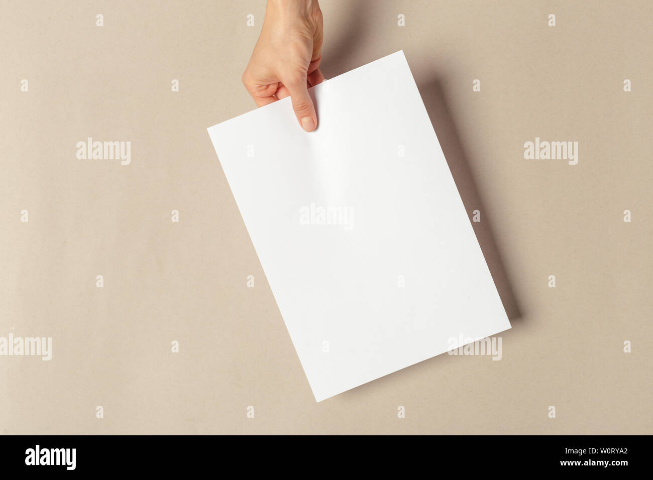 Hand holding papers a4 size Stock Photo - Alamy