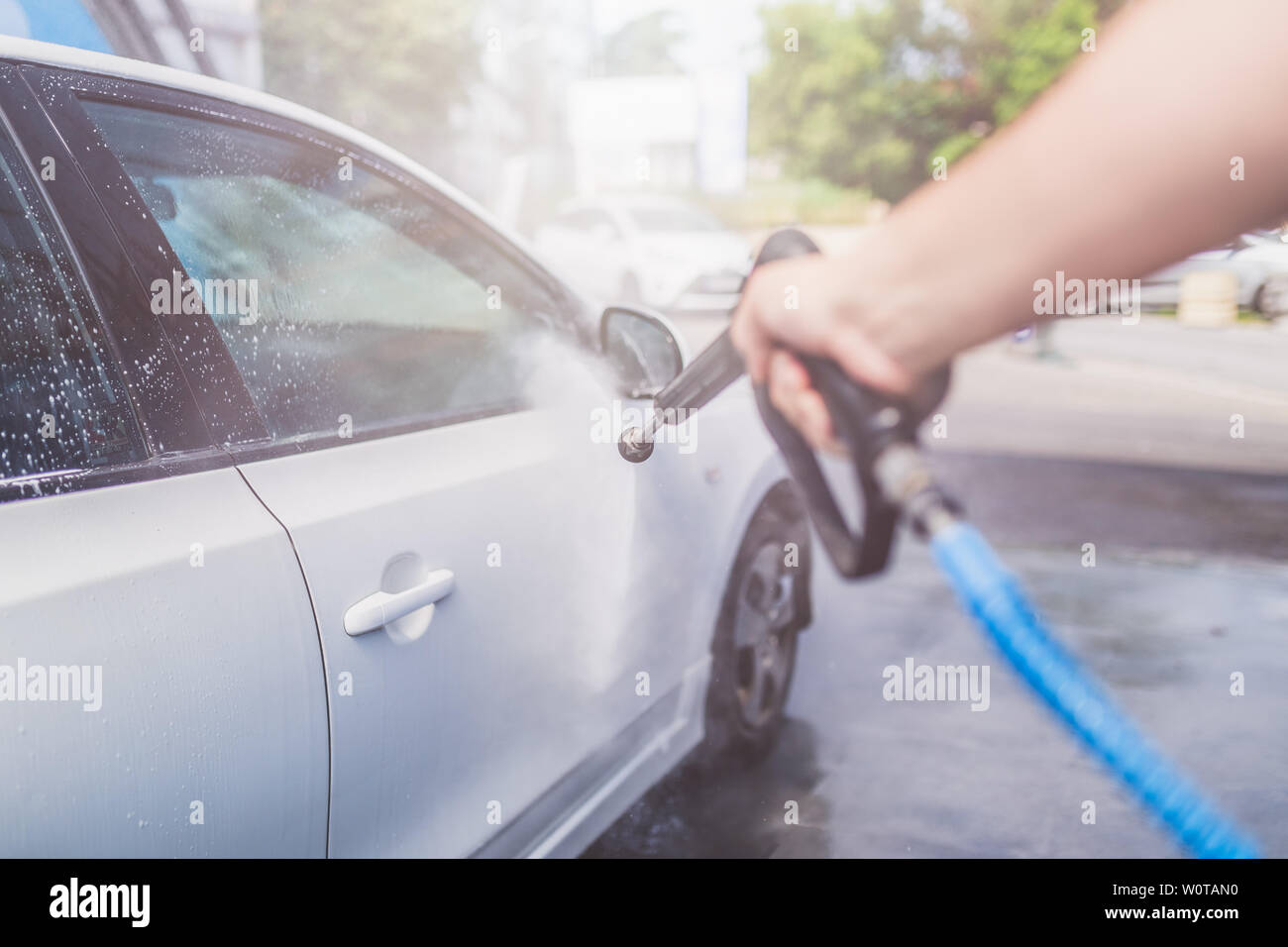 Close up of man hand washing car with pressure washer outdoors Stock ...