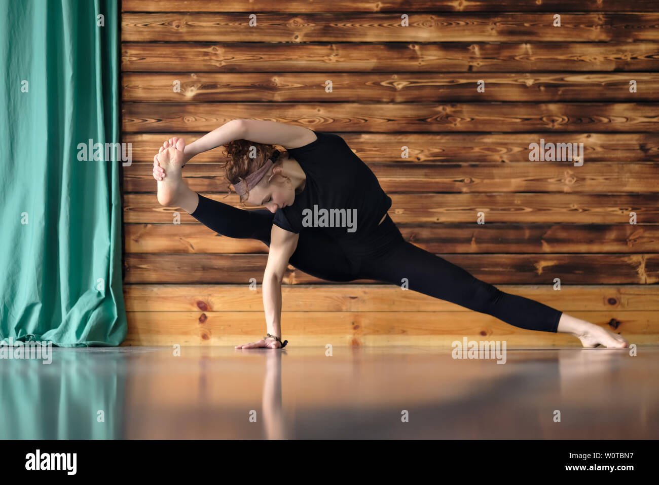 Curly woman working out, doing side plank pose with stretching Stock ...