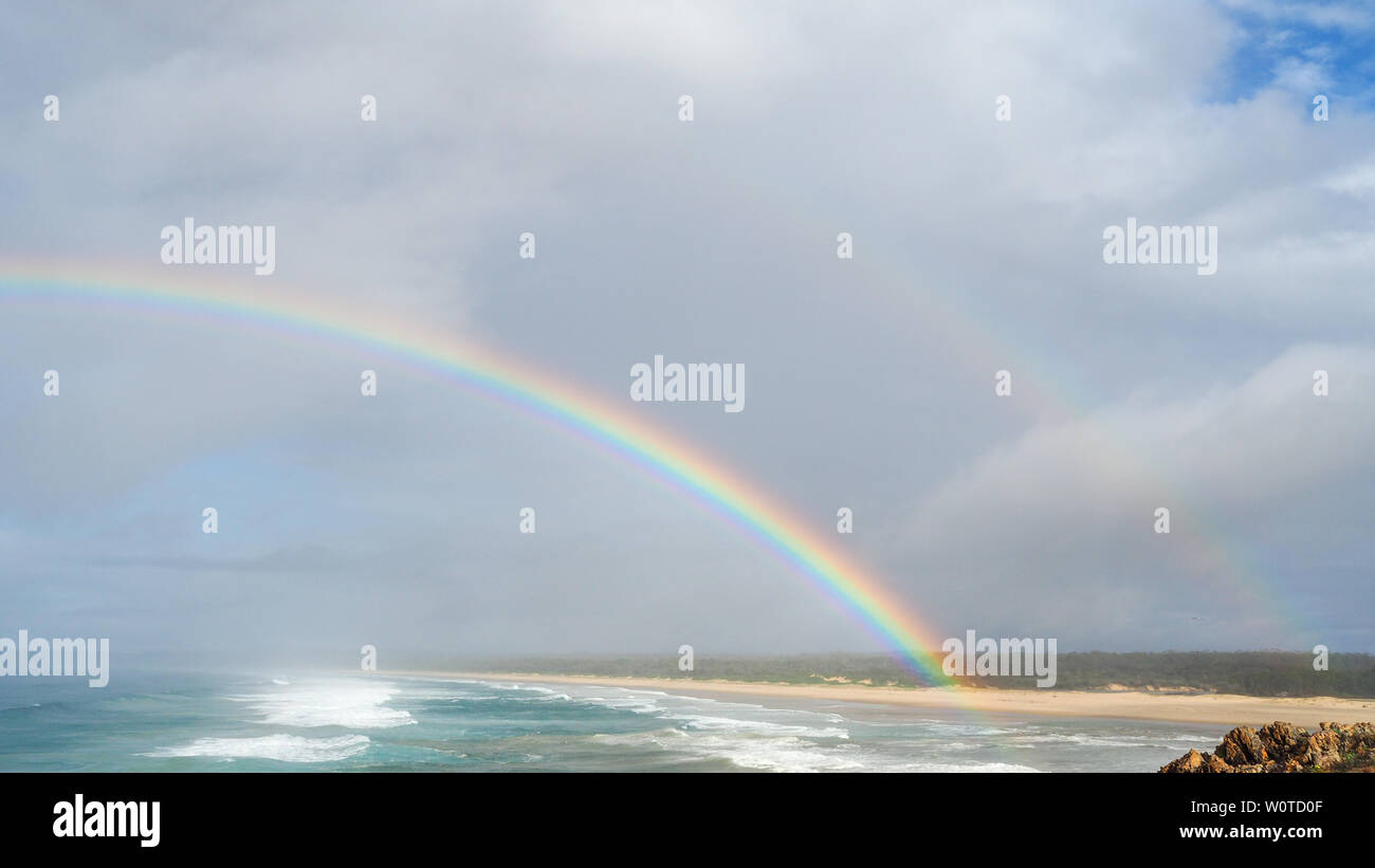 Double Rainbow over the sea water and waves at the beach, Pacific Ocean ...