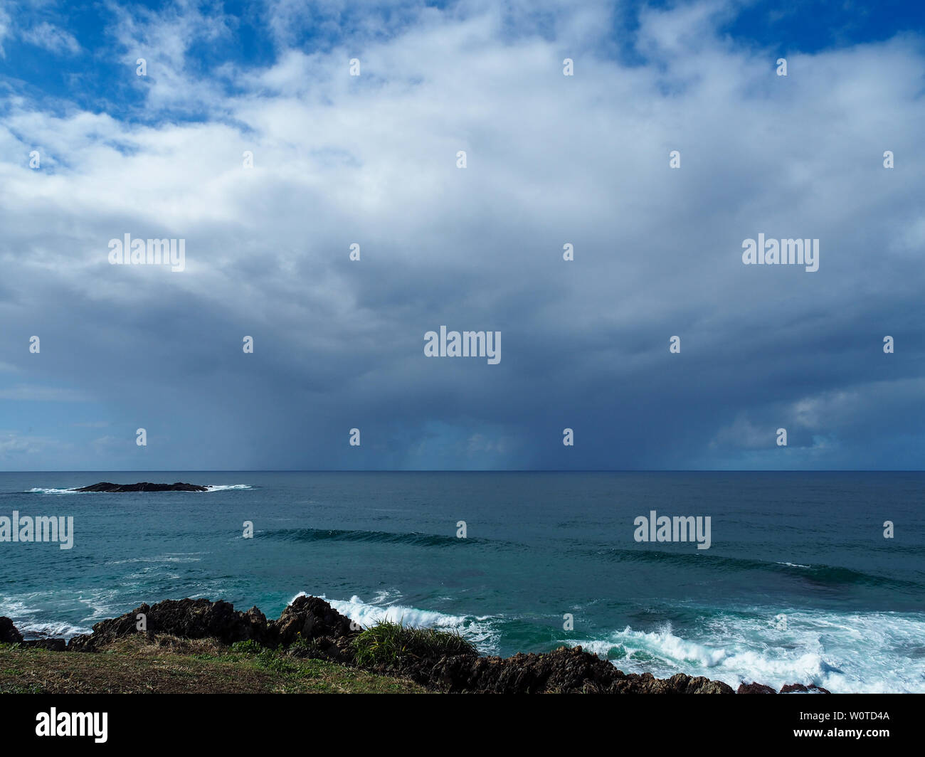 Dramatic Storm clouds over the ocean with horizon, raining out at sea ...