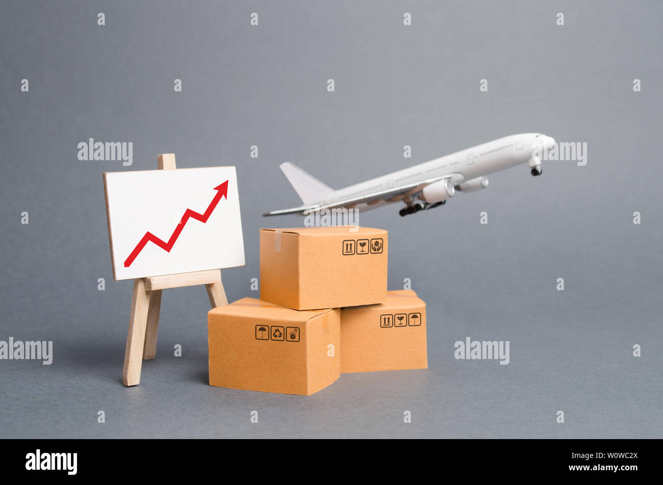 Airplane plane takes off behind stack of cardboard boxes and stand with ...